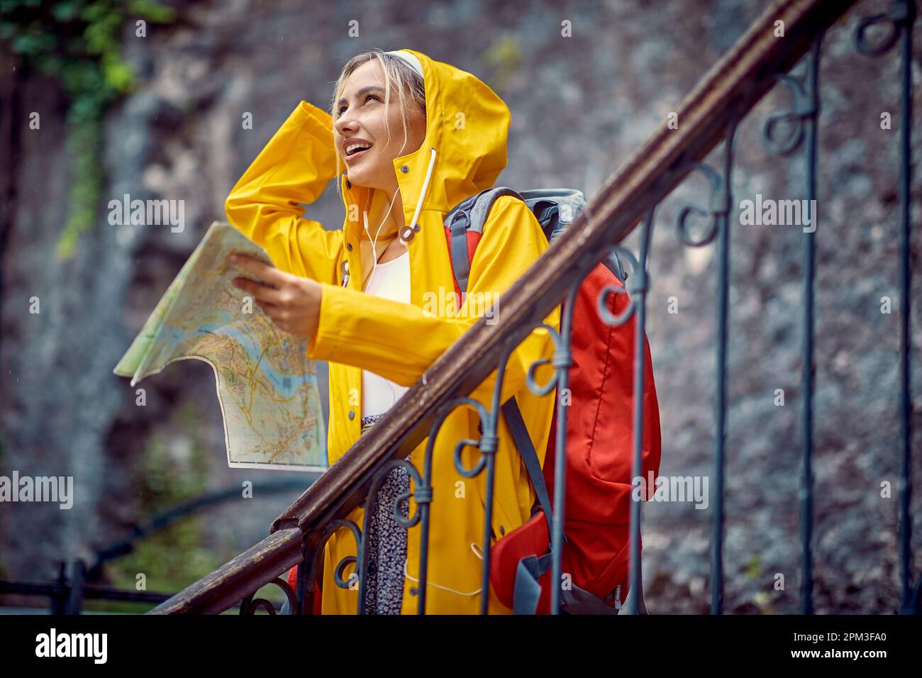 Walk In City In Rain Young Blonde With Map And In Raincoat Enjoying