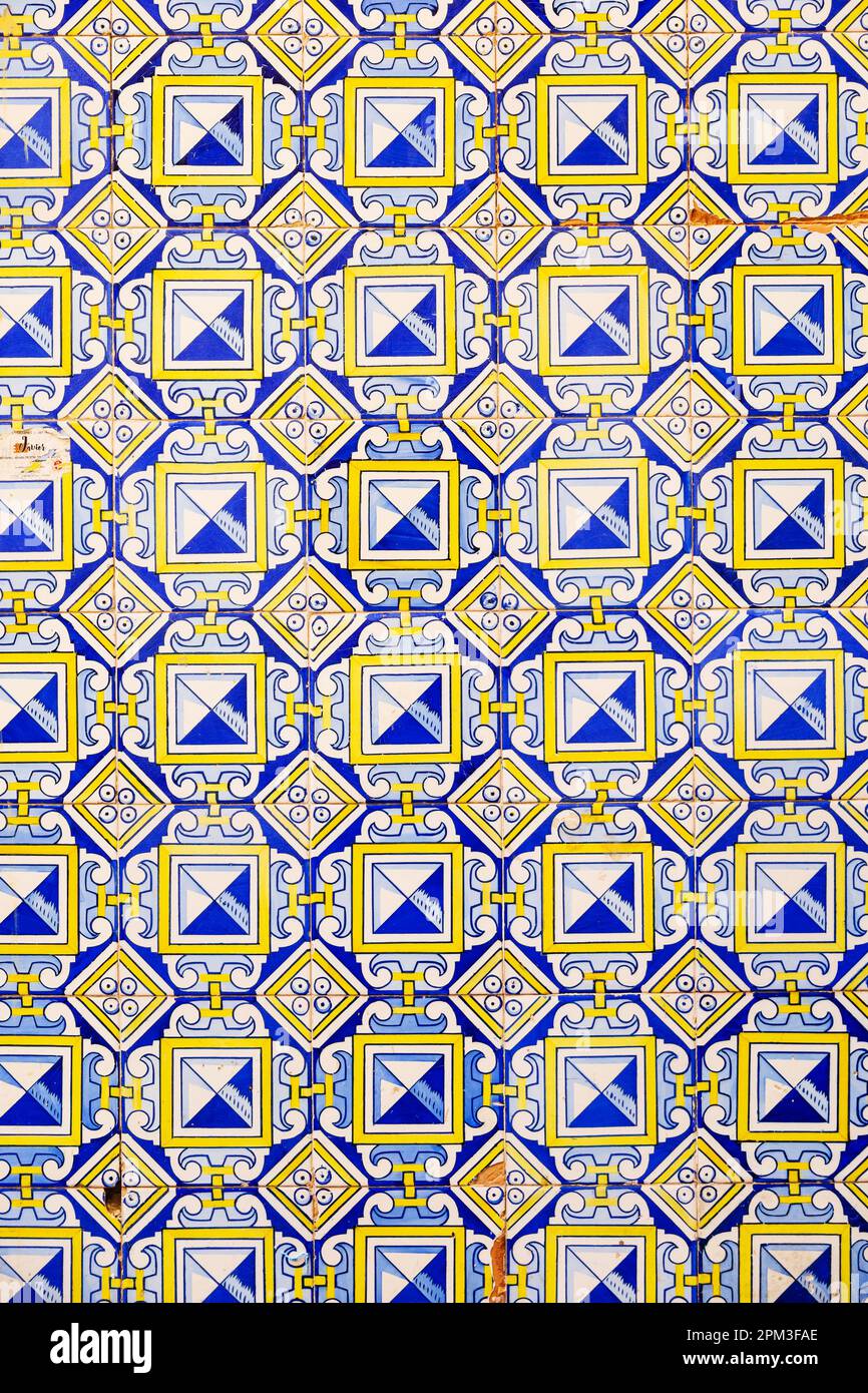 Blue, white and yellow geometric patterned tiles on a wall. Cadiz ...