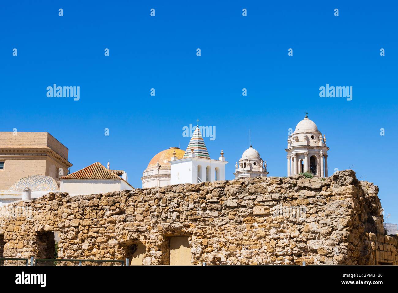 View of the towers of the Cathedral of Cadiz seen over the Roman walls ...