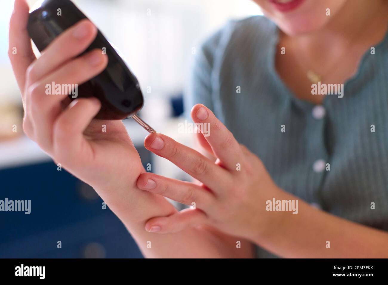 Close Up Of Diabetic Girl At Home Testing For Blood Glucose Level With ...
