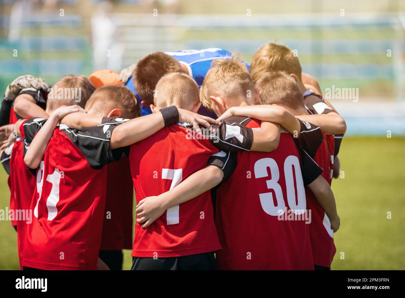 Soccer kids with the coach. Portrait of a friendly football team ...
