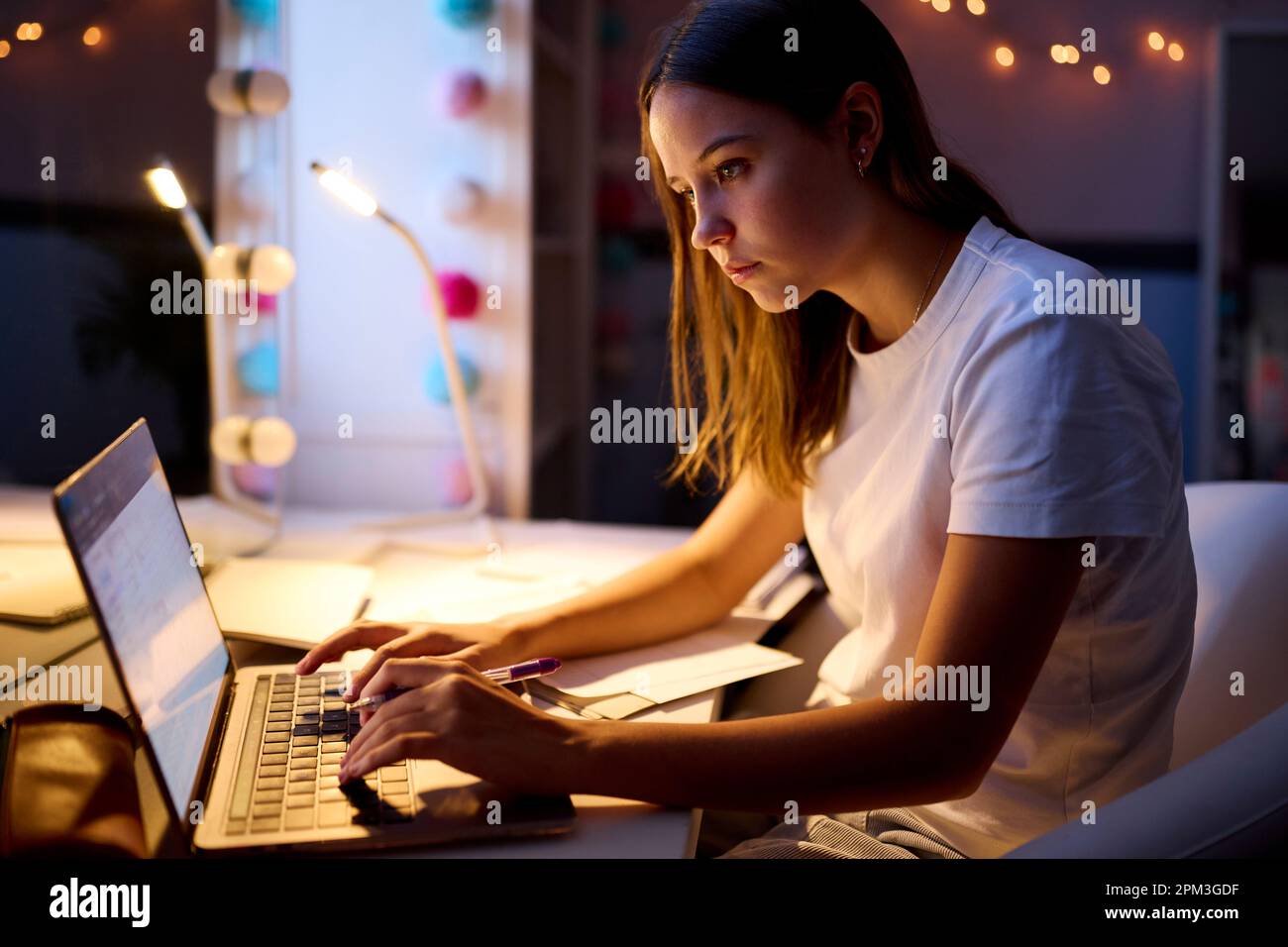 Teenage Girl Studying At Home With Laptop In Bedroom Desk At Night ...