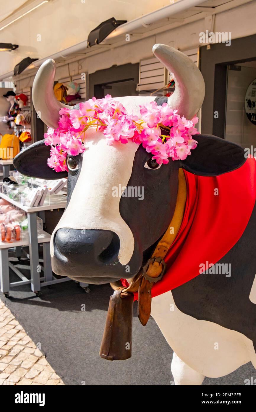 model of bull cow with pink garland outside store restaurant cafe in in ...