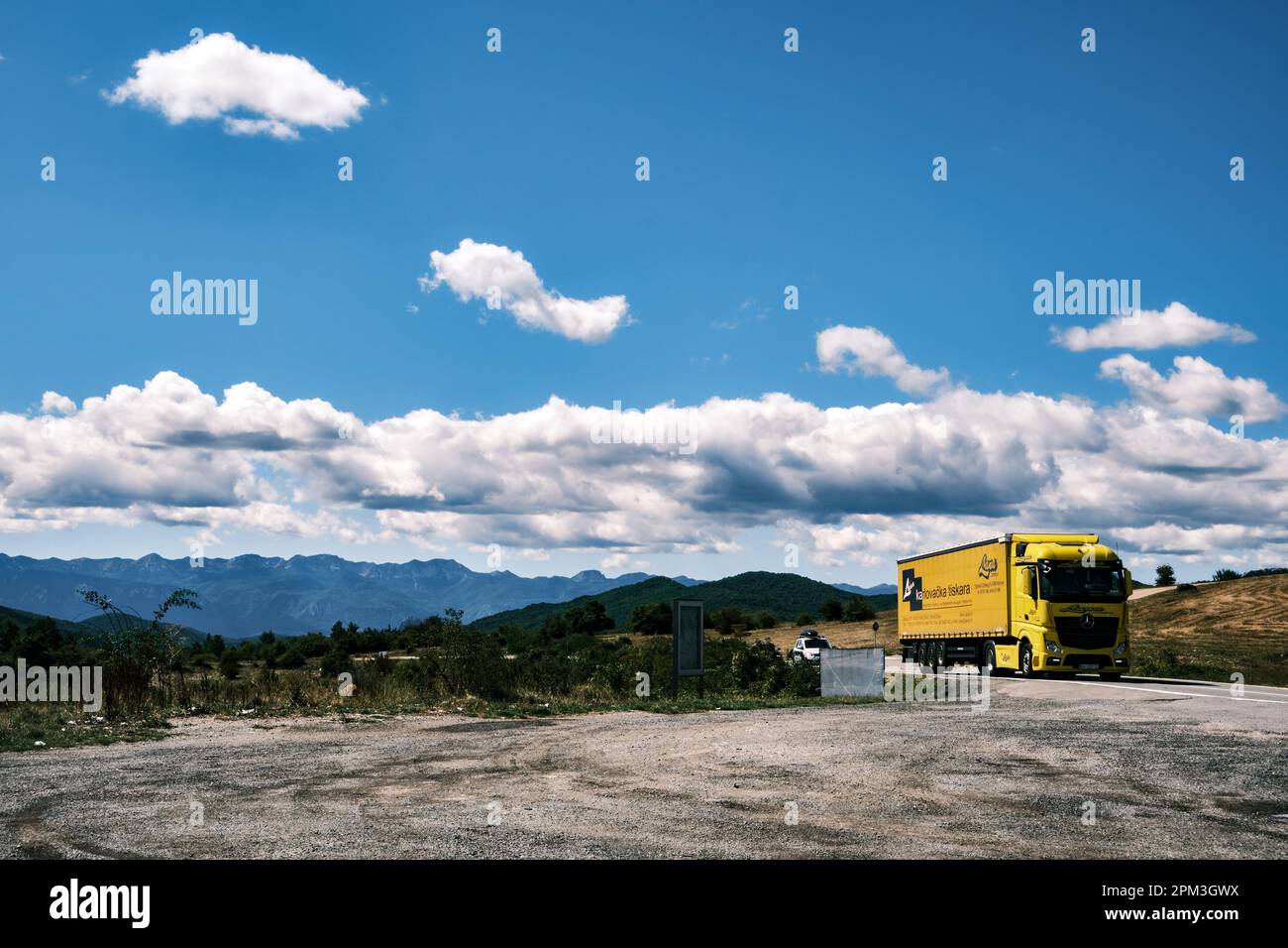 A cargo-carrying semi-truck traveling down a paved road, Croatia ...