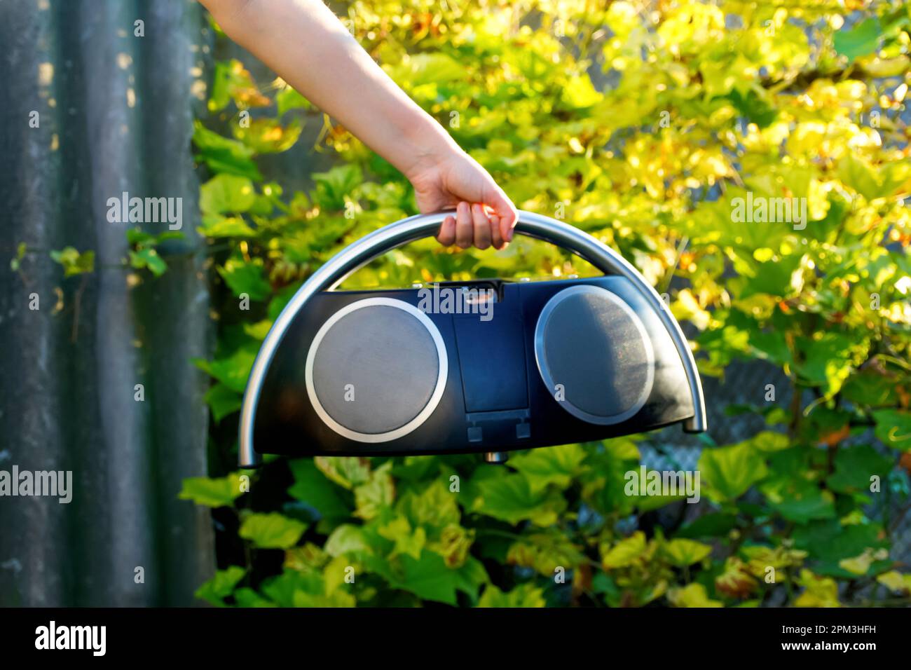 Boombox. Defocus hand holding retro music recorder on nature. Retro ...
