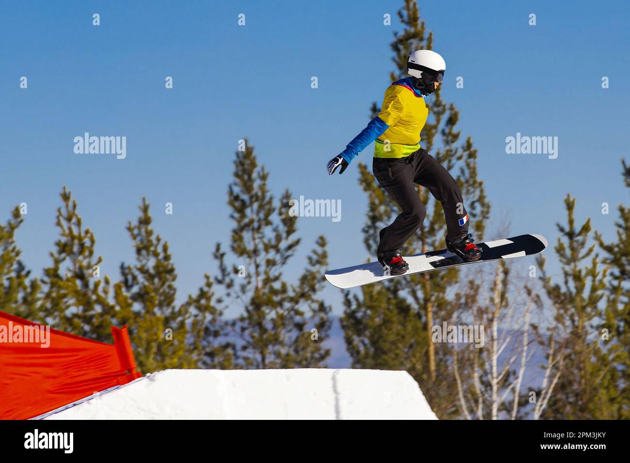 woman athlete snowboarders in team France jumping drops in snowboarding ...