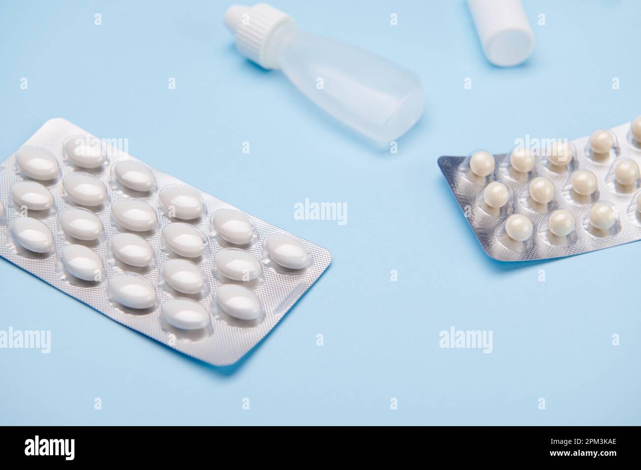 Still life with blisters of medical pills and therapeutic drops ...