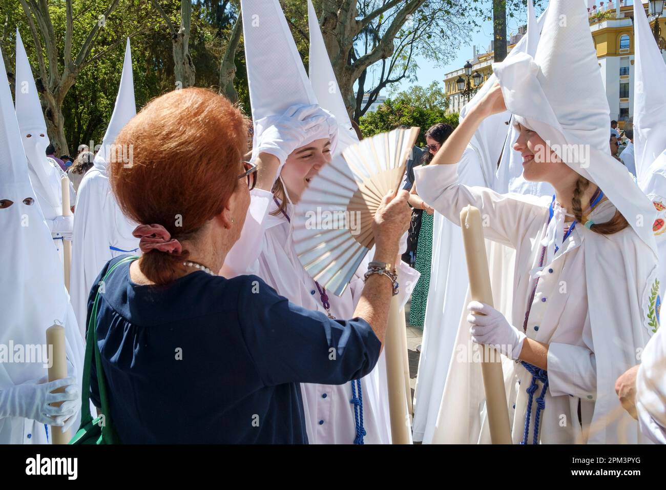 Seville Spain. Holy Week, Semana Santa. Young ladies wearing nazareno ...