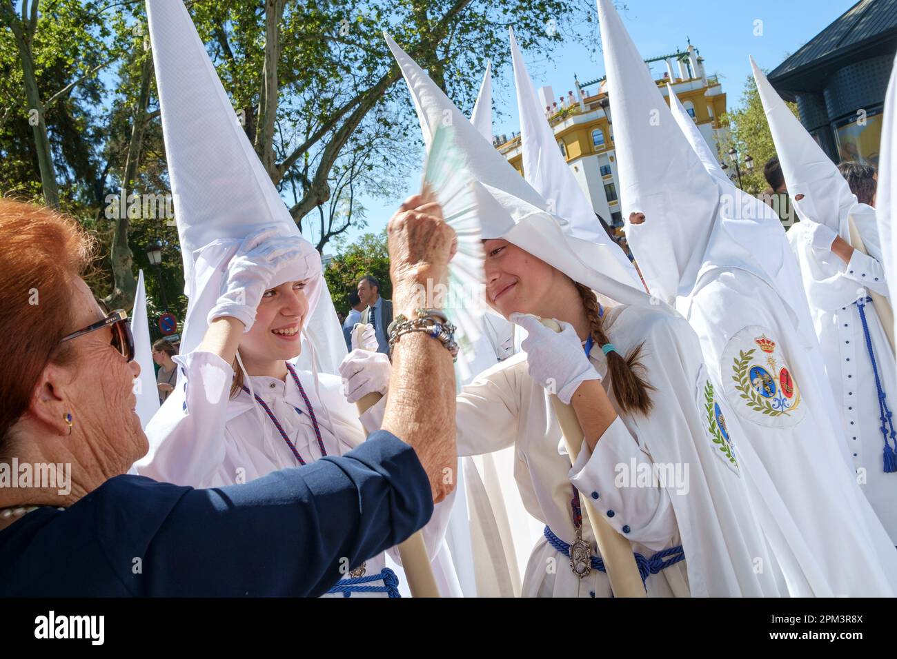 Seville Spain. Holy Week, Semana Santa. Young ladies wearing nazareno ...