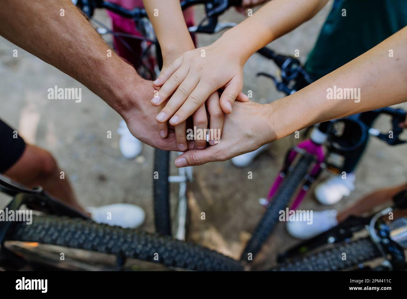 Top view of family holding hands together during bicycle trip, concept ...