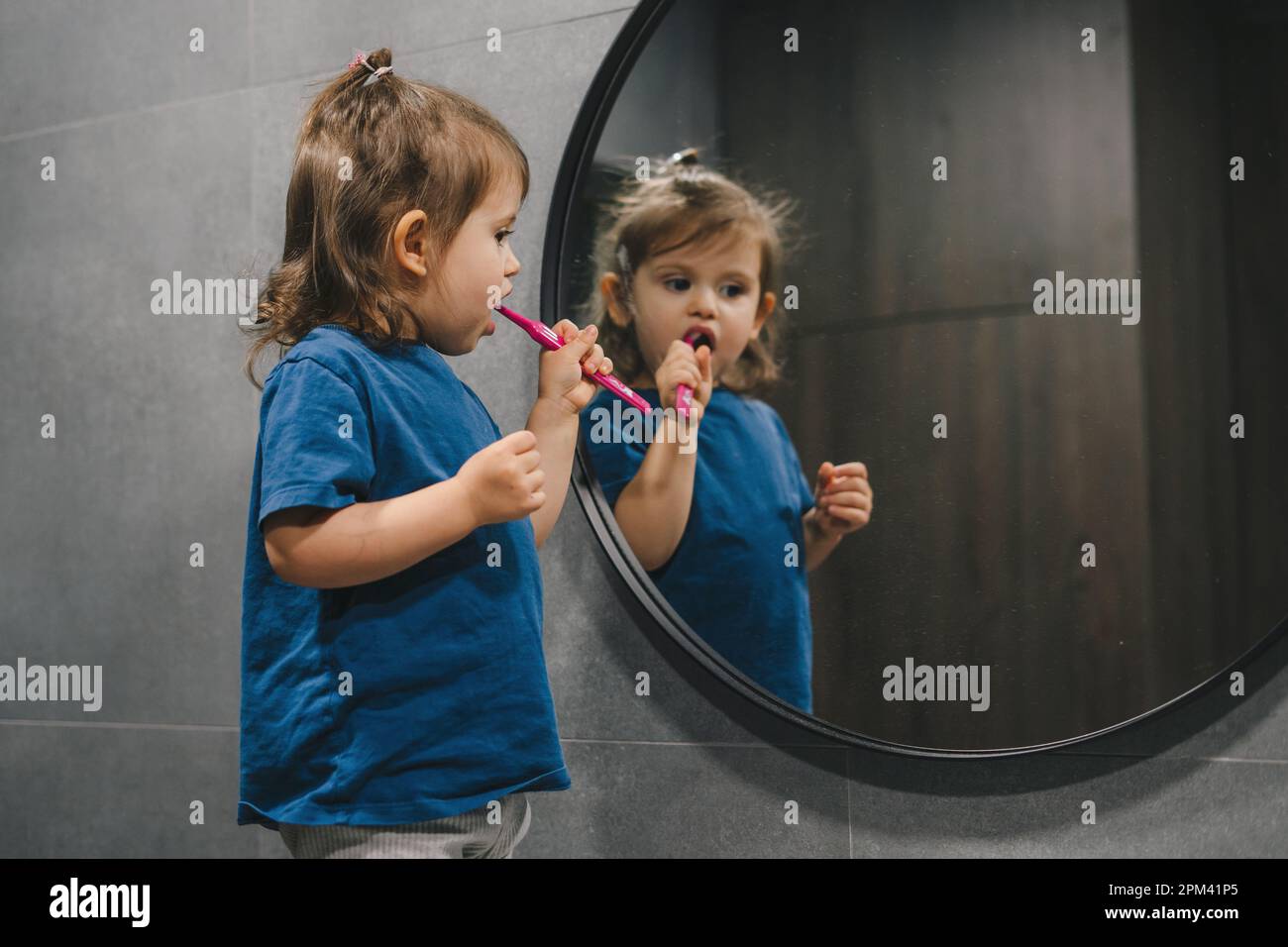 Baby girl brushing teeth with toothbrush as daily kids routine and self ...