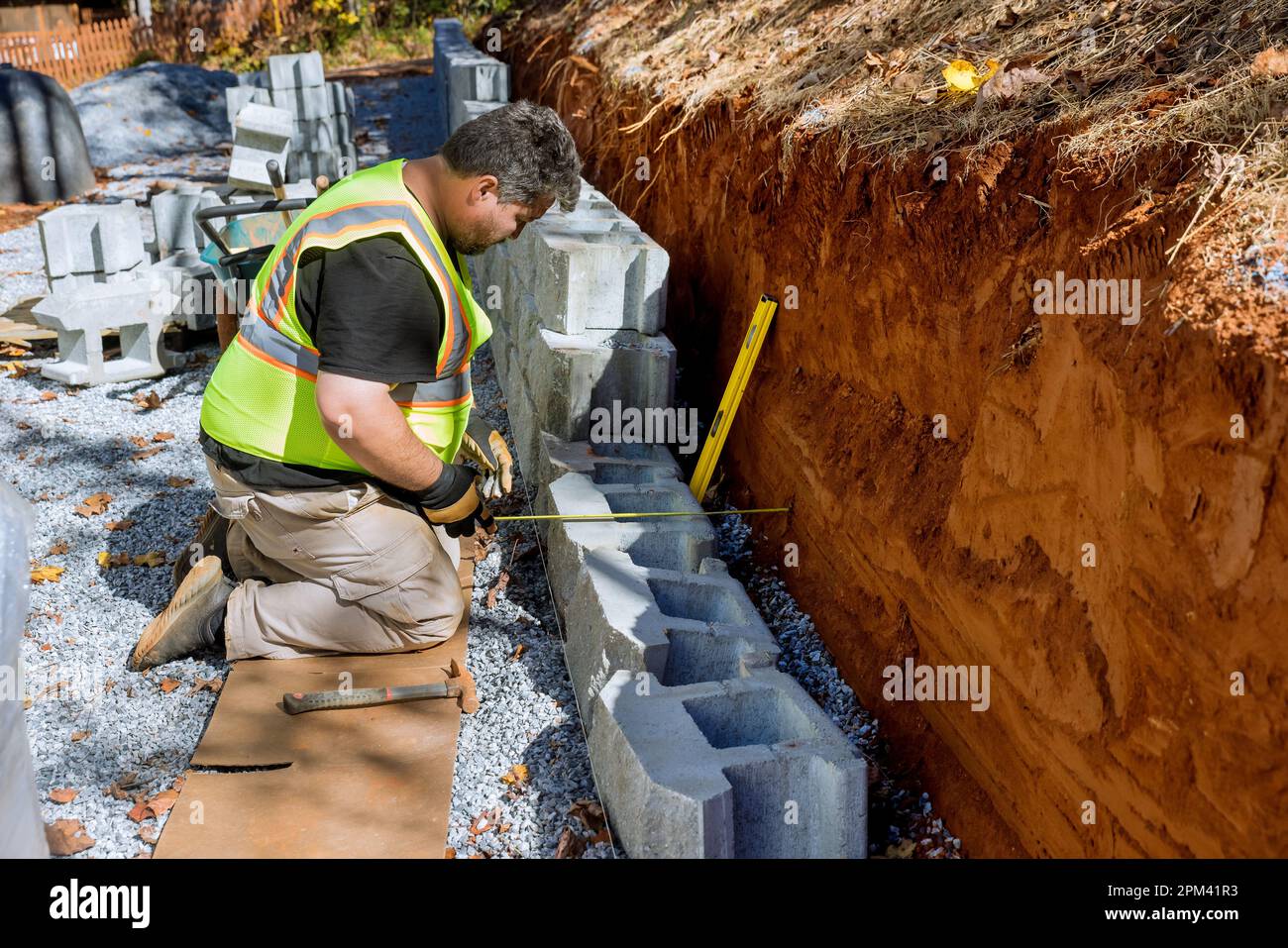 Contractor are working during the installation large block retaining ...