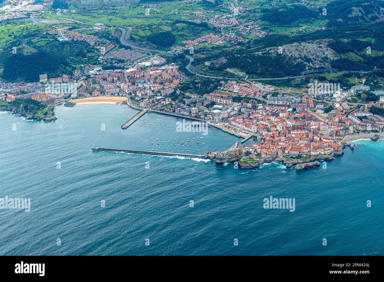 aerial of village Castro Urdiales with 2 piers and sandy beach in ...