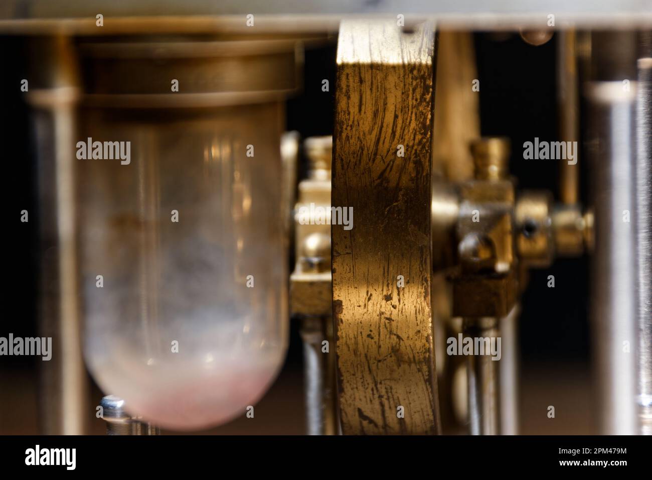 closeup of a stirling engine construction with wooden table and black ...