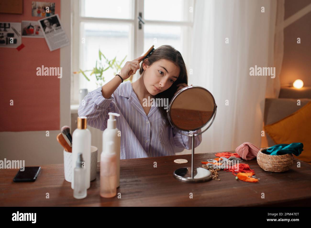 Teenage girl doing her skin care routine and hairstyle Stock Photo - Alamy