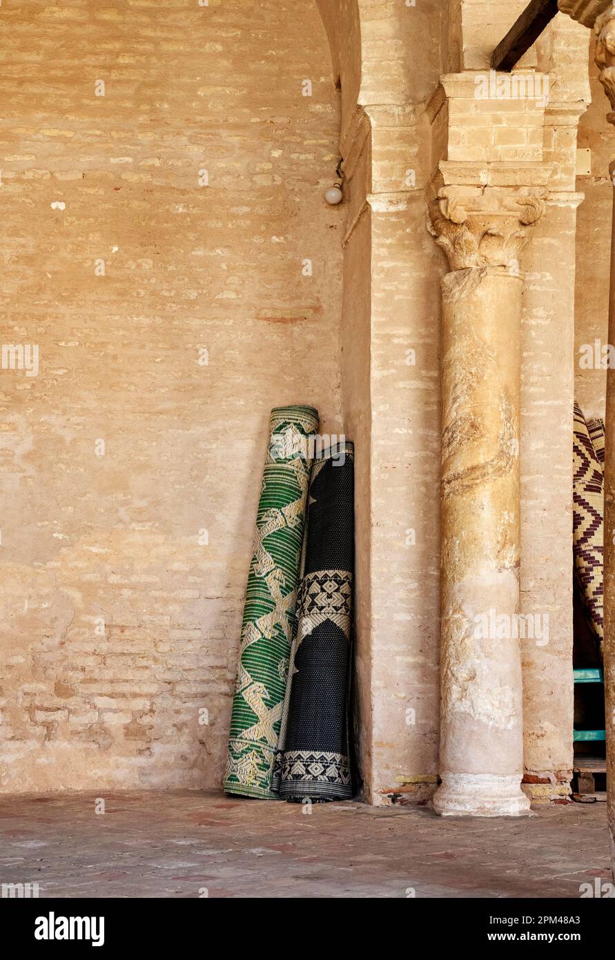 Sousse, Tunisia, January 15, 2023: Rolled up prayer rugs in a corner of ...