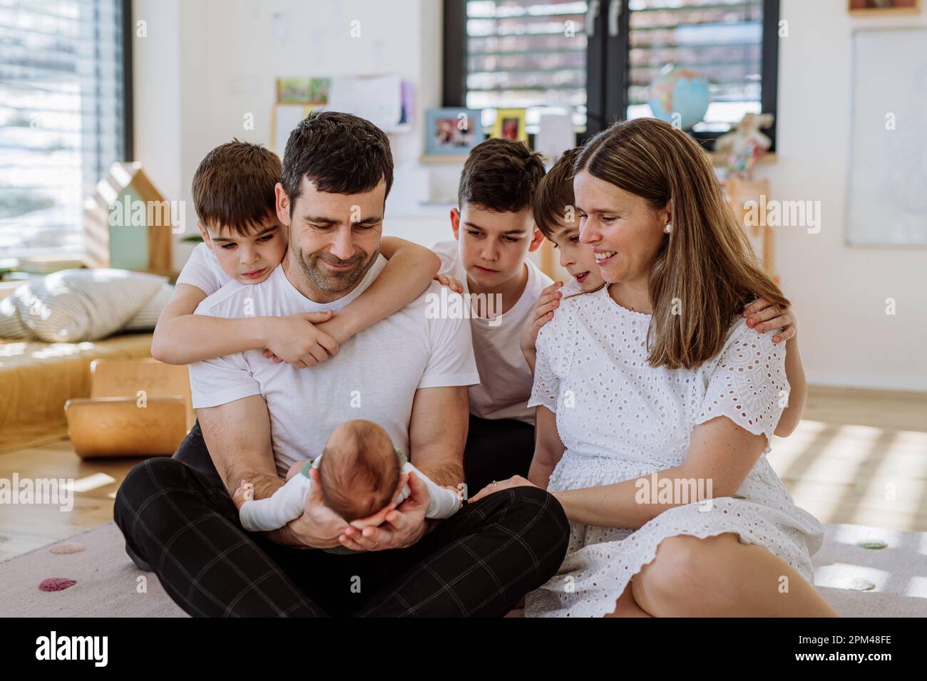 Big family with four kids enjoying their newborn baby Stock Photo - Alamy