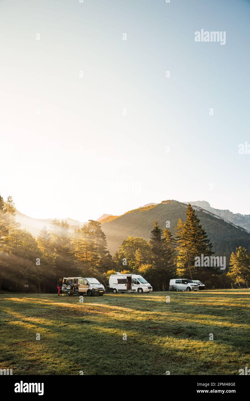 Some camper vans in a valley with amazing landscape views of forest ...