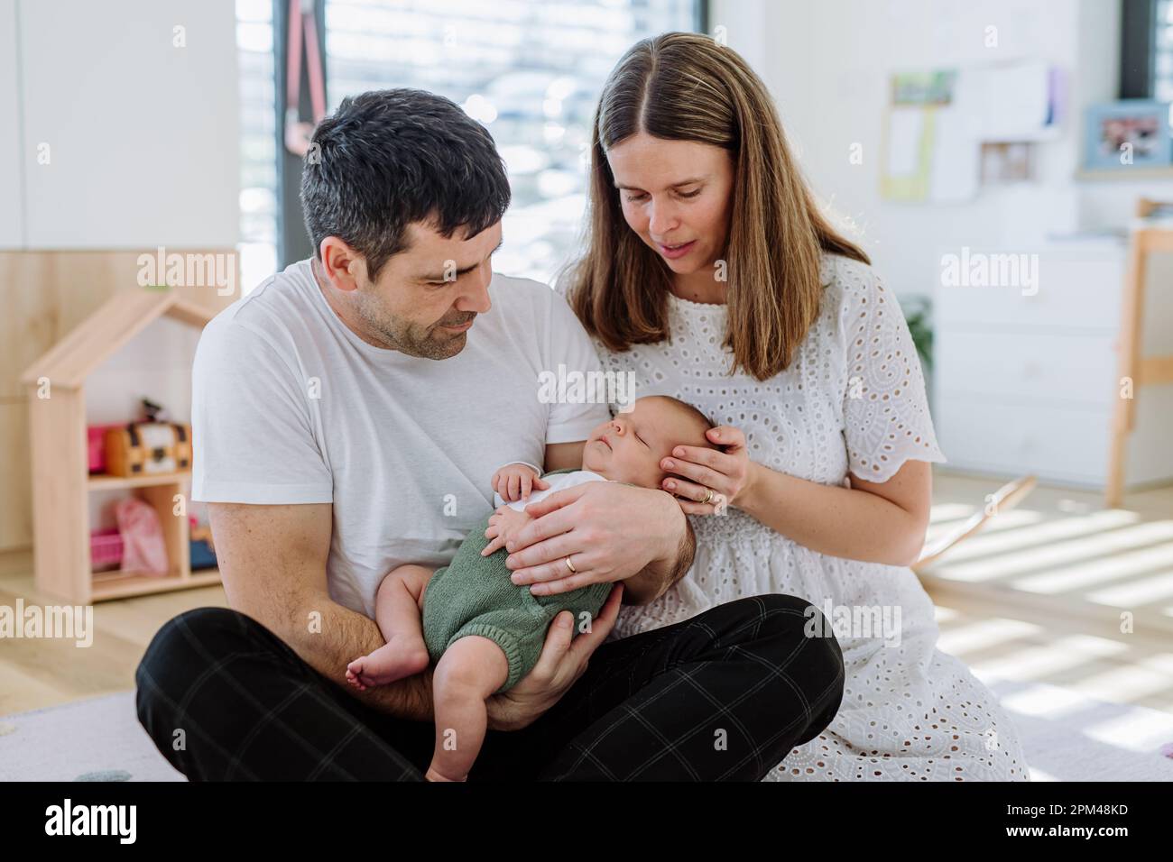 Happy parents cuddling with their newborn baby Stock Photo - Alamy
