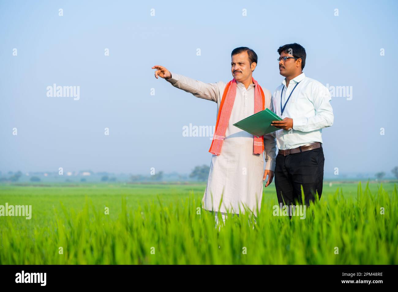 Banker or officer making notes about crop or farmland by asking farmer ...