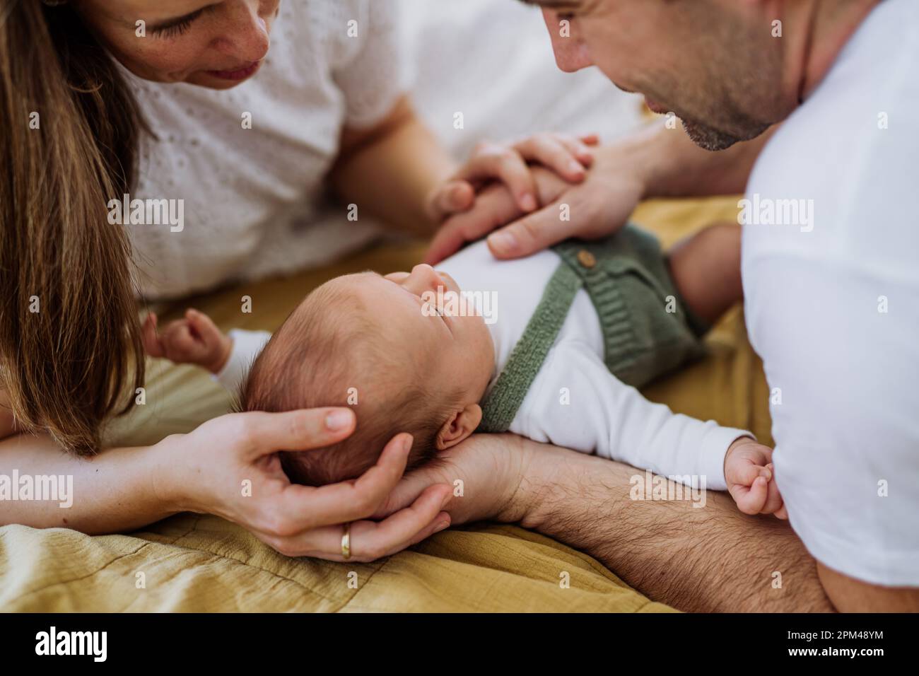 Happy parents cuddling with their newborn baby Stock Photo - Alamy