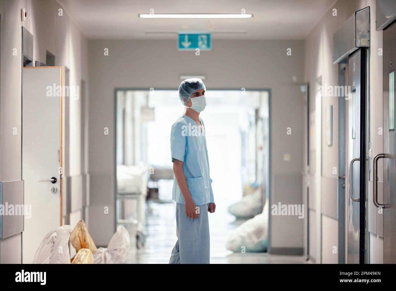 A tired surgeon leaves the operating room after the operation, a tired ...