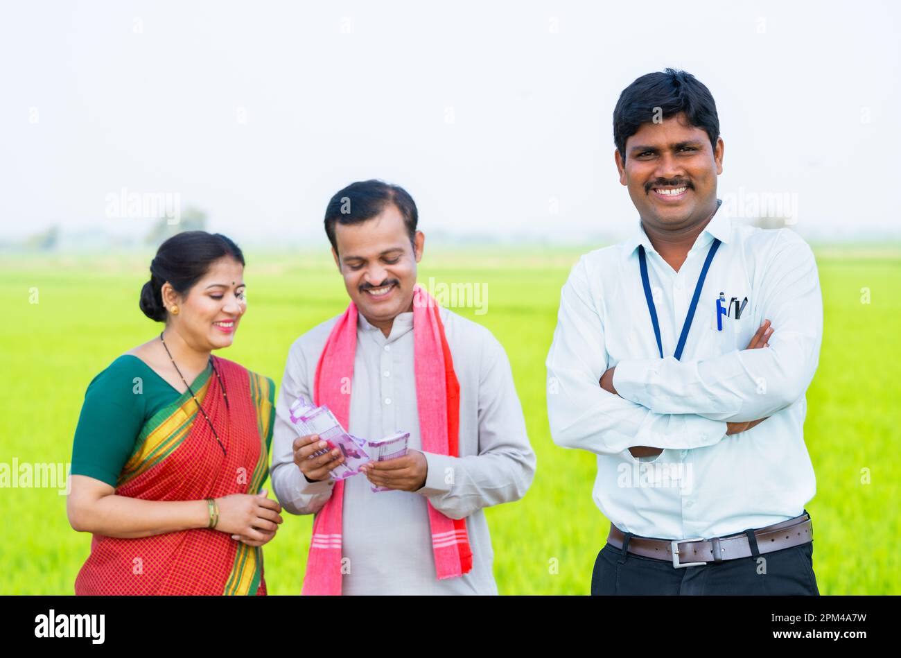 Happy Indian banker standing with crossed arms by looking camera in ...