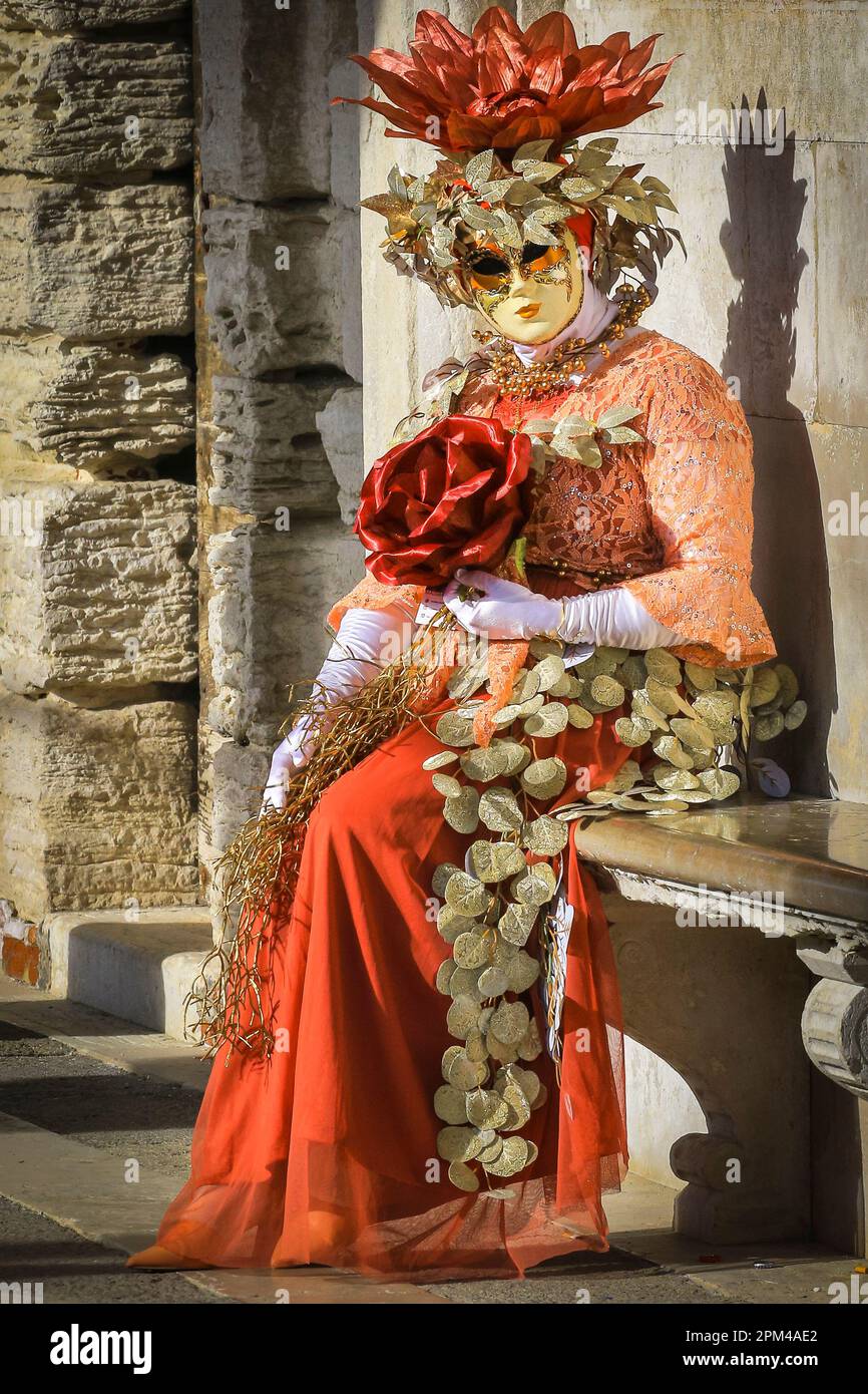 Venice carnival, costumed woman, carnival participant in red dress ...