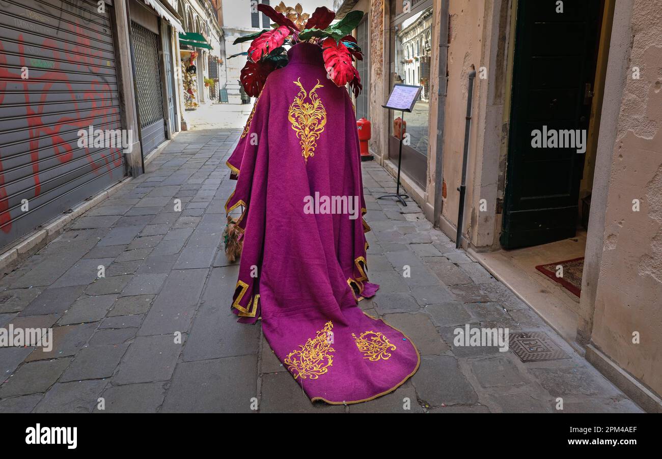 Venice carnival, costumed participant in historic scarlet cape costume ...