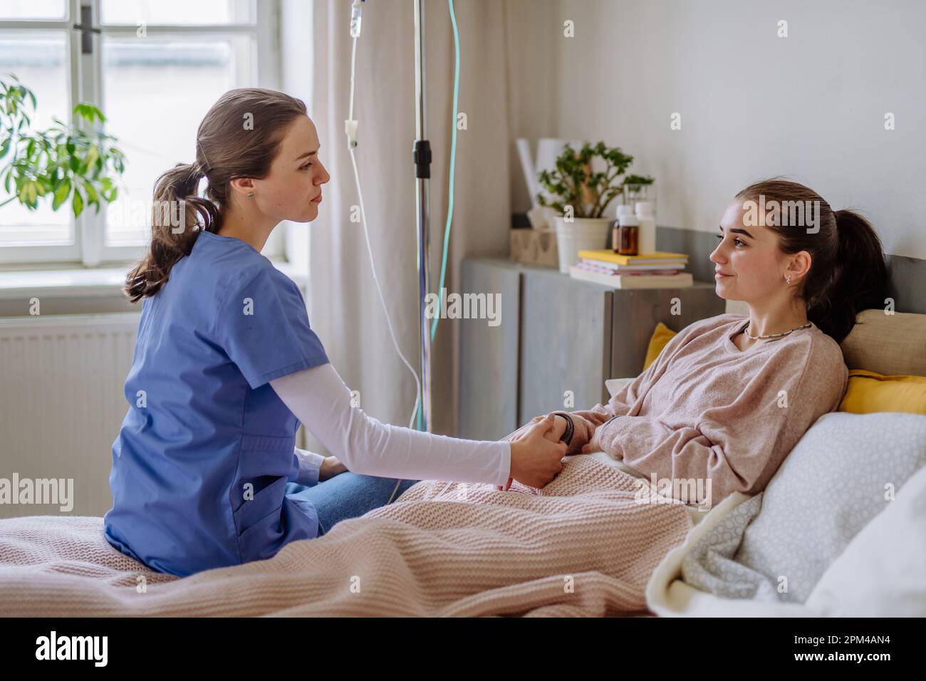 Young nurse taking care of teenage girl Stock Photo - Alamy