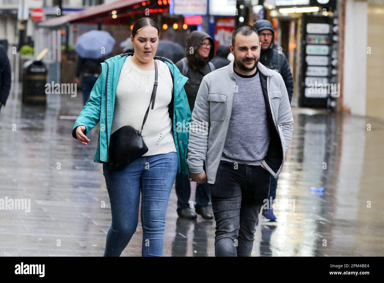 A couple are caught during wet and blustery conditions in central ...