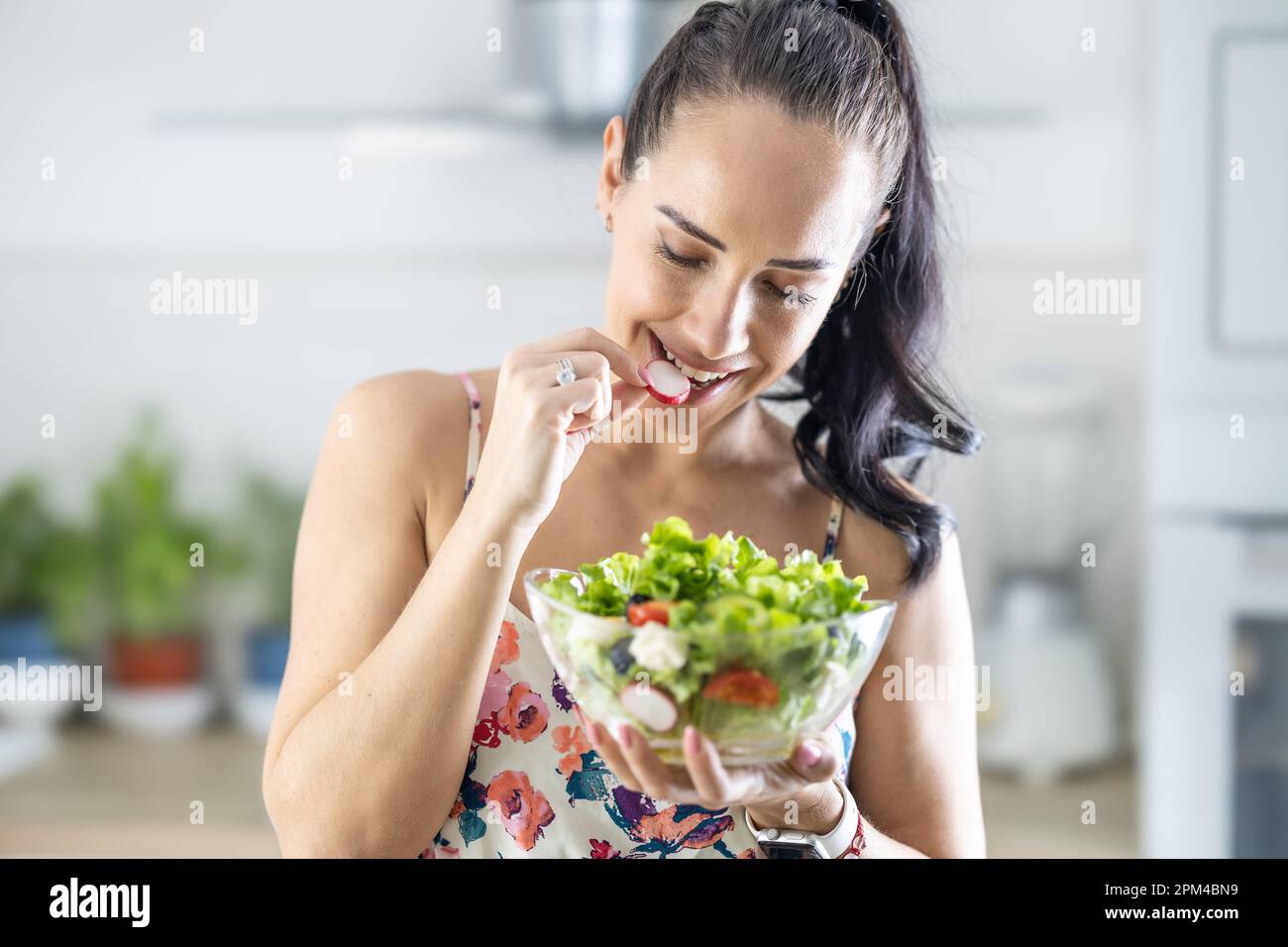Healthy lifestyle young woman eating lettuce salad. Young brunette ...