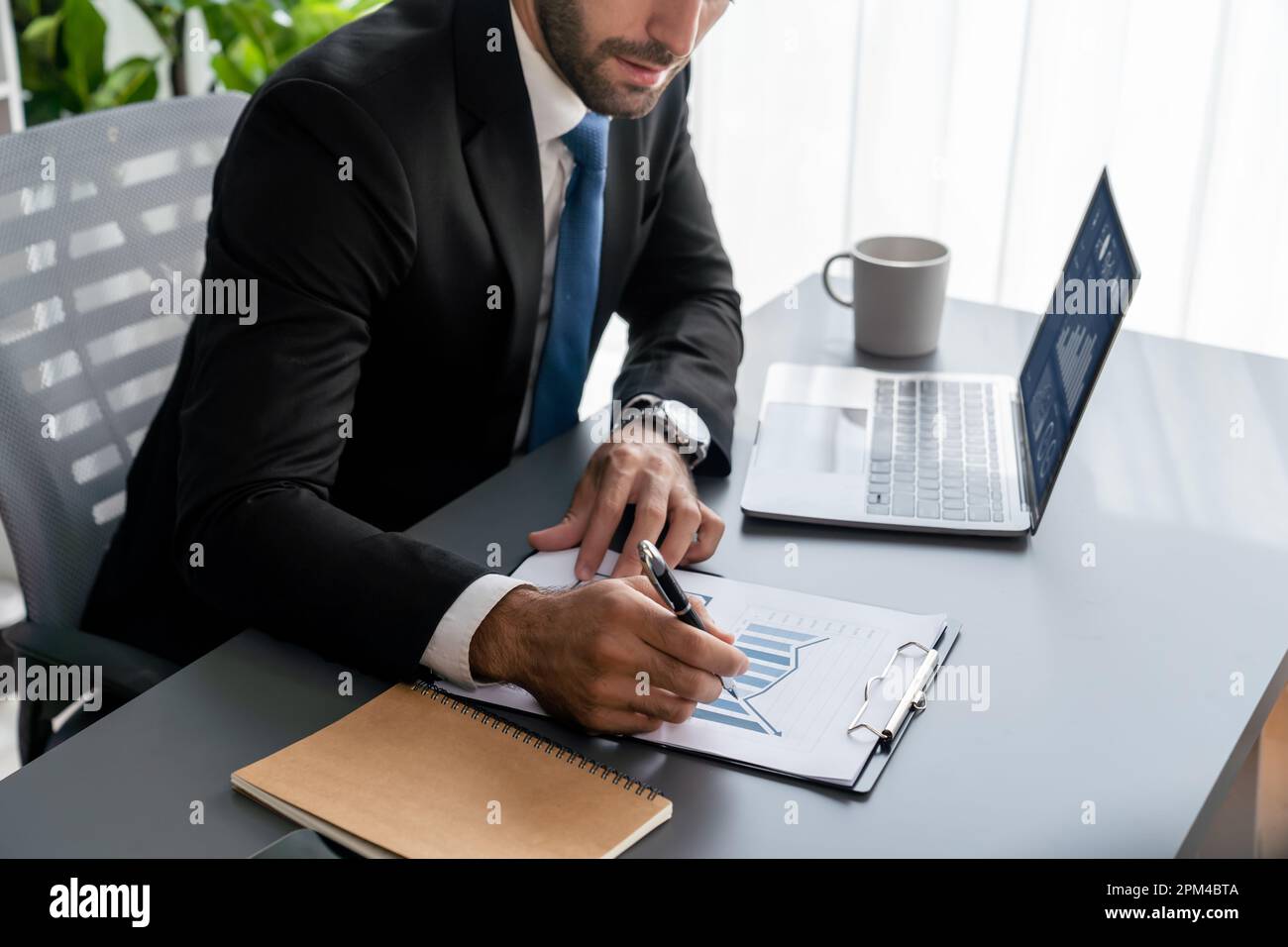 Modern professional businessman at modern office desk using laptop to ...
