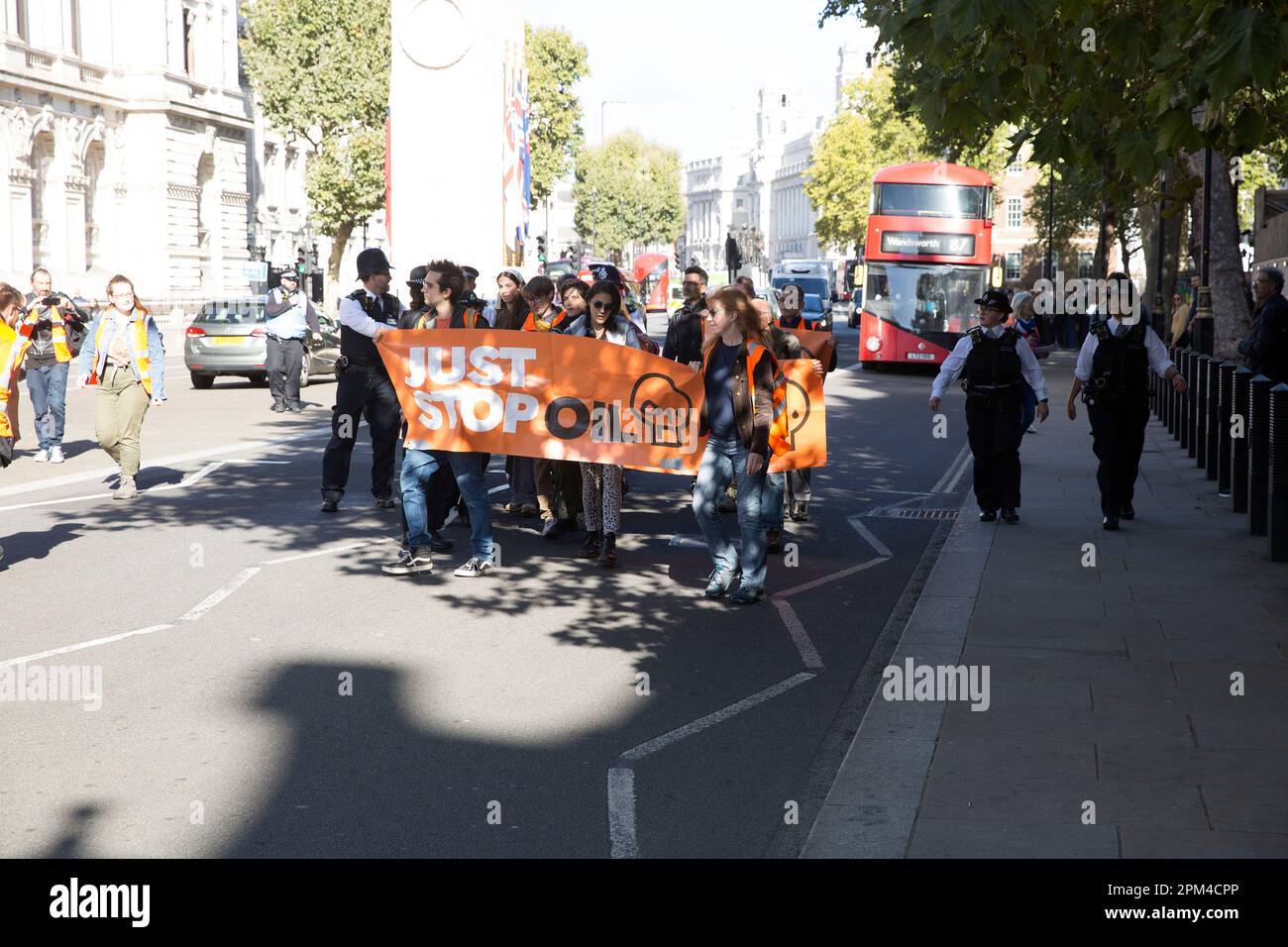 ‘Just Stop Oil’ activists try to hold a banner in front of the traffic ...