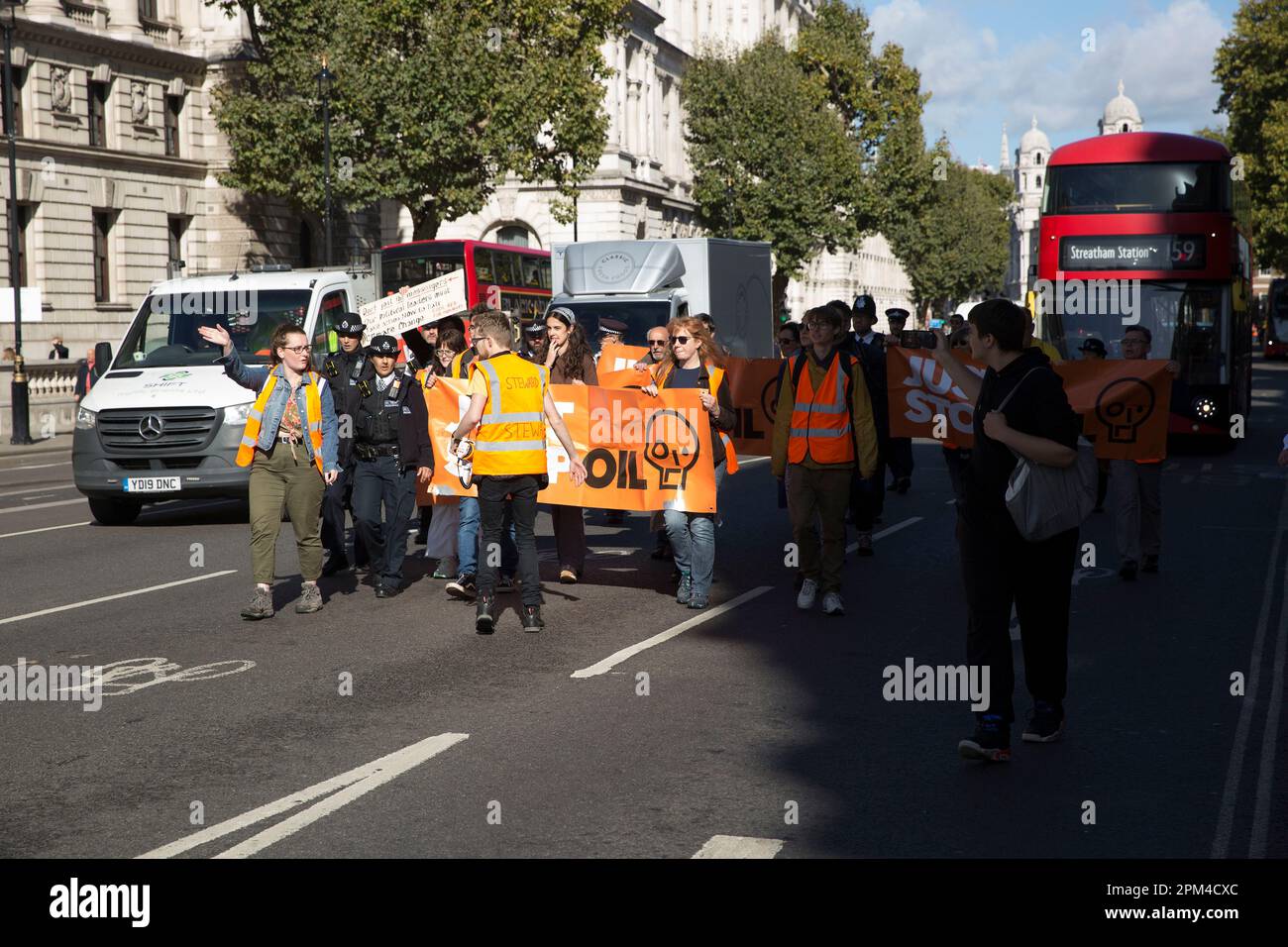 ‘Just Stop Oil’ activists try to hold a banner in front of the traffic ...