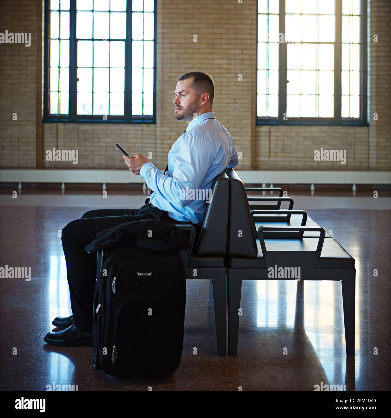 Traveling with technology. a confident businessman using his smartphone ...