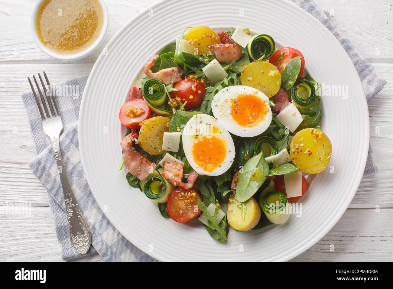 French peasant salad or salade paysanne with lettuce, bacon, cheese ...