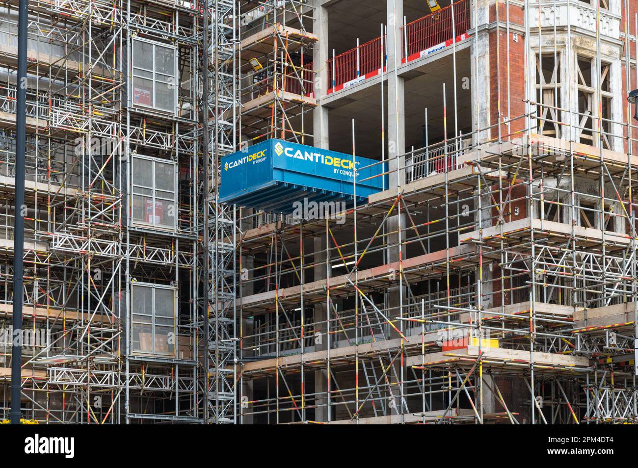 Construction site with scaffolding, goods and personnel hoist and ...