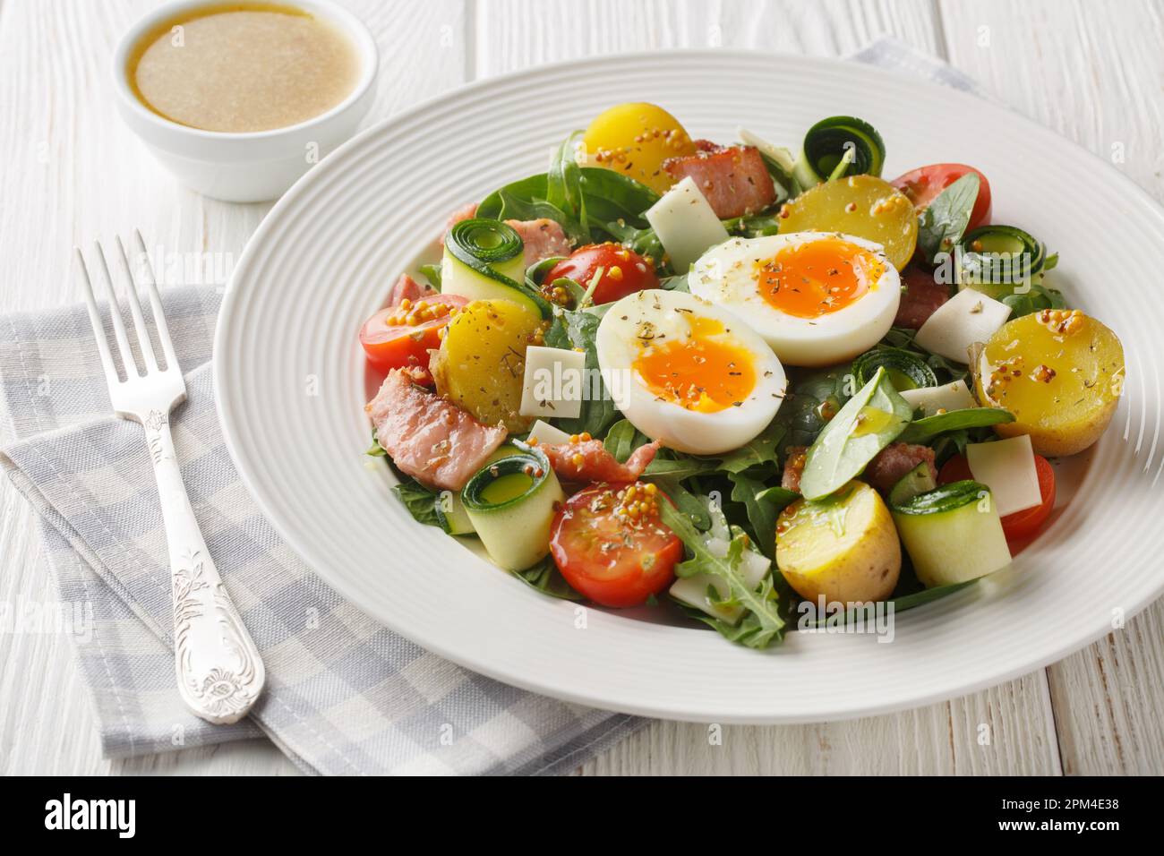 French peasant salad or salade paysanne with lettuce, bacon, cheese ...
