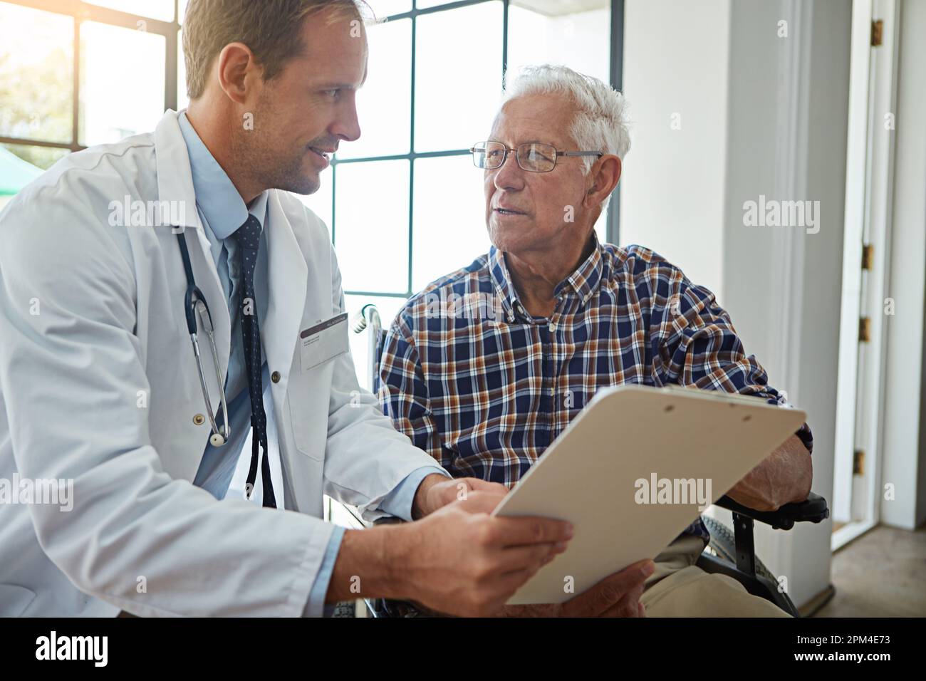 Its nothing to worry about...a male doctor talking to a senior patient ...