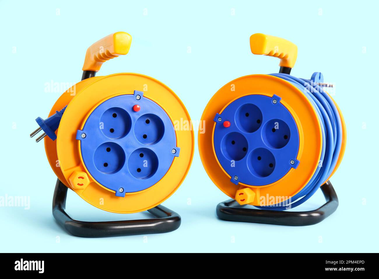 Extension electric cable reels on color background Stock Photo - Alamy