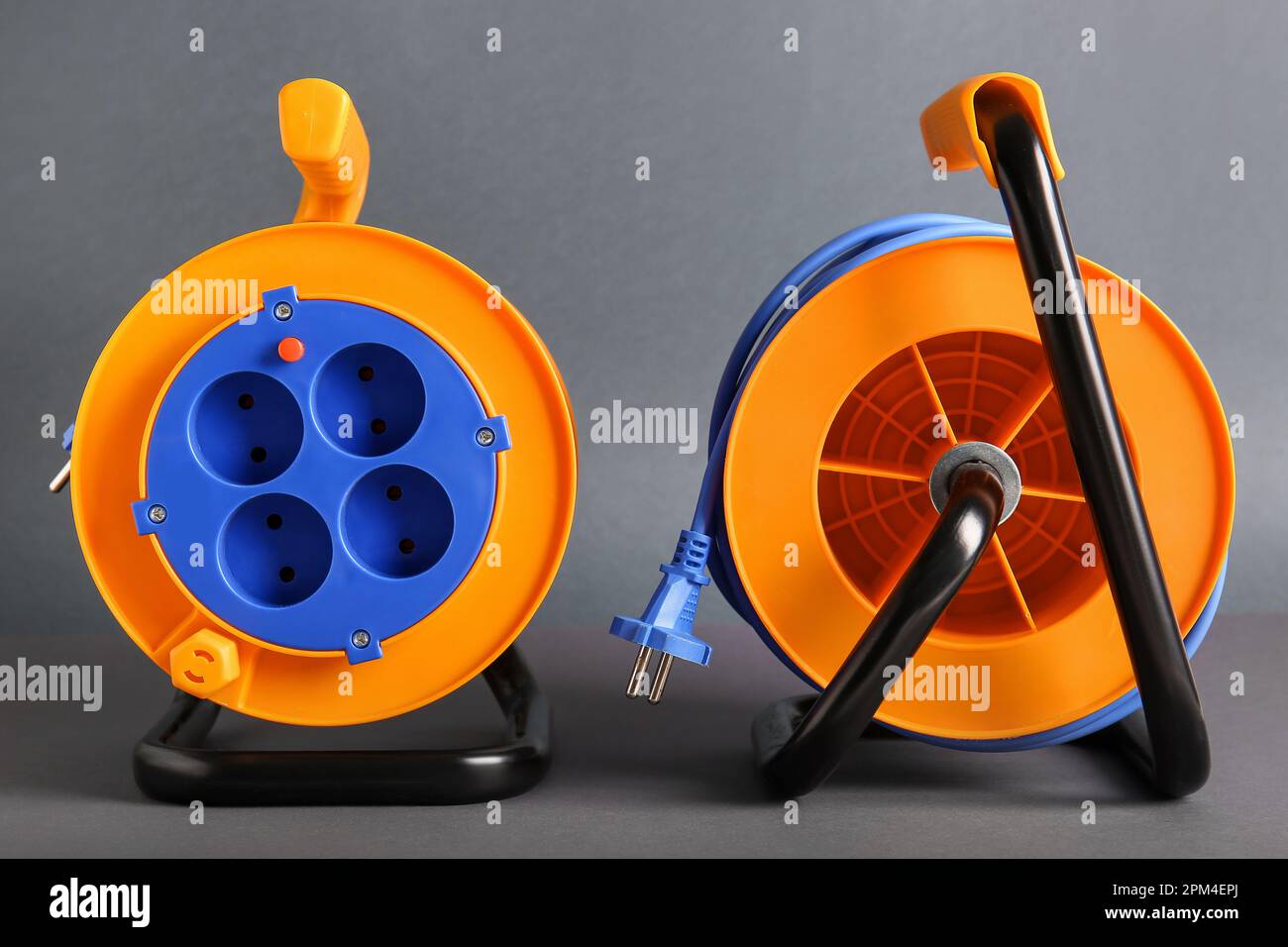 Extension electric cable reels on dark background Stock Photo - Alamy