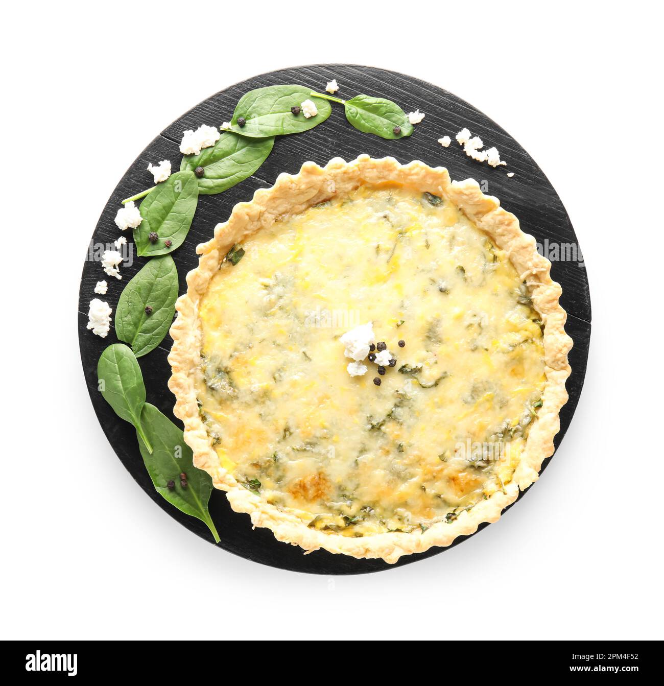 Board with delicious quiche, spinach leaves and cottage cheese isolated ...