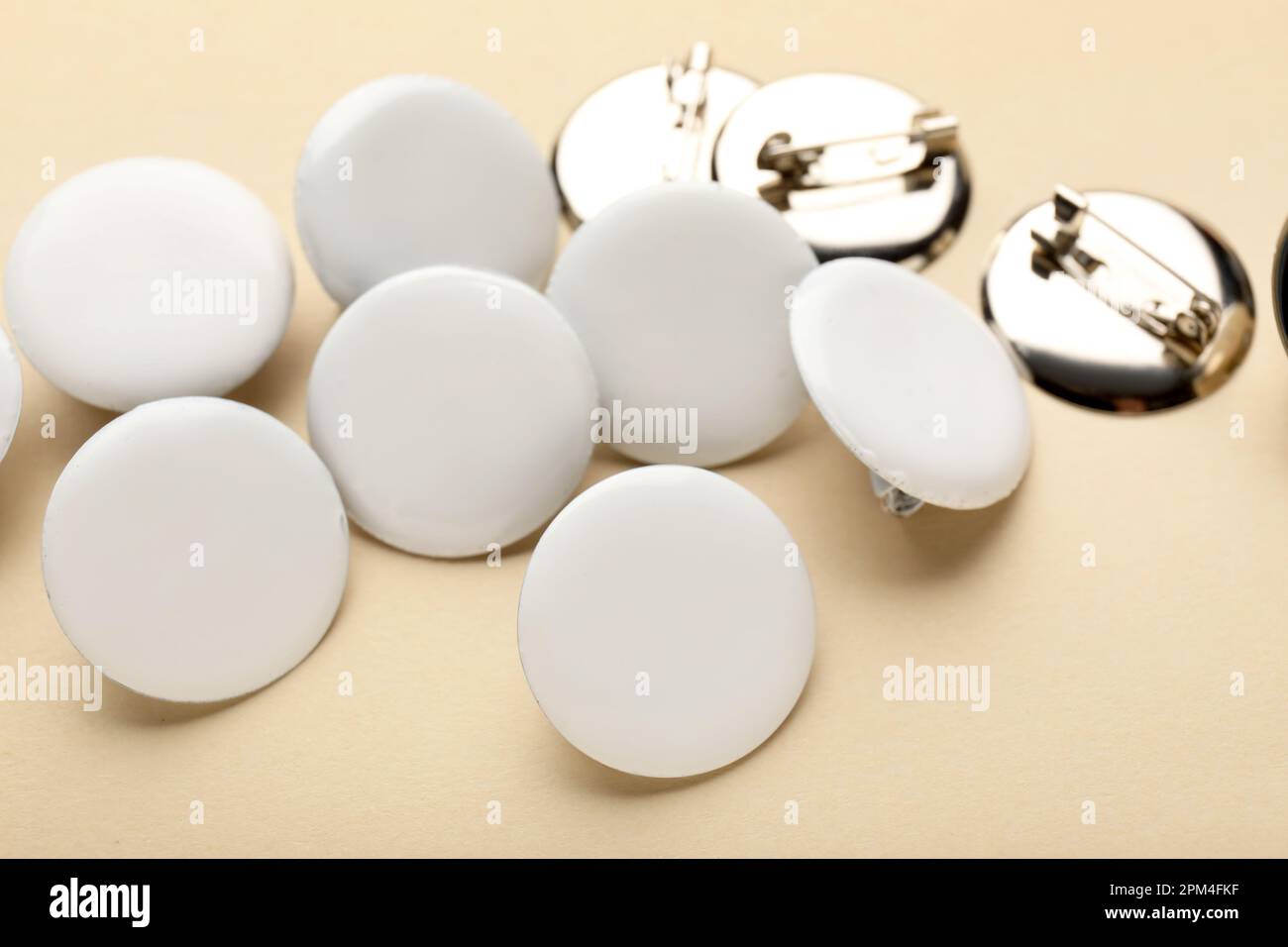Blank white badges on beige background Stock Photo - Alamy