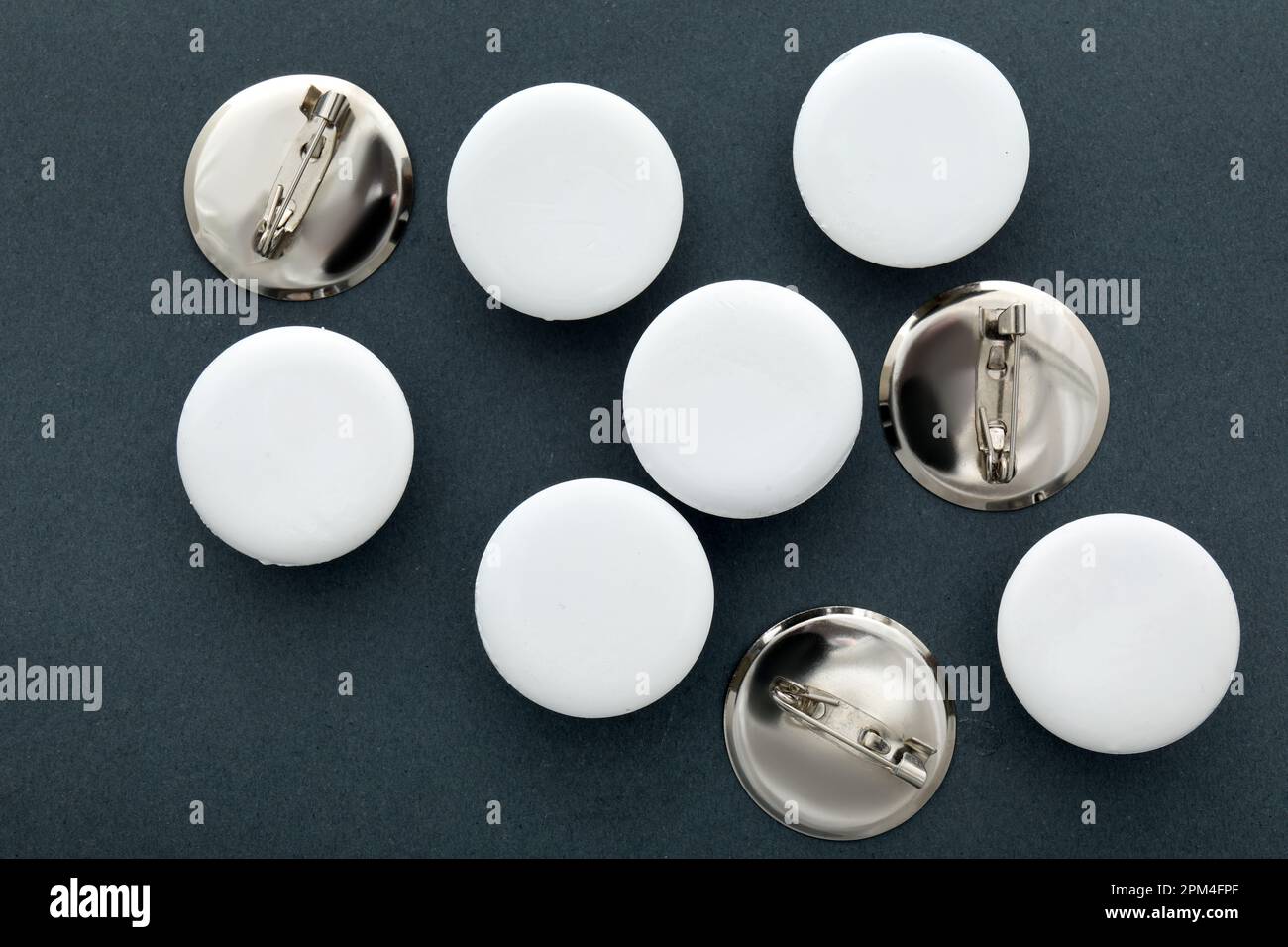 Blank white badges on grey background Stock Photo - Alamy