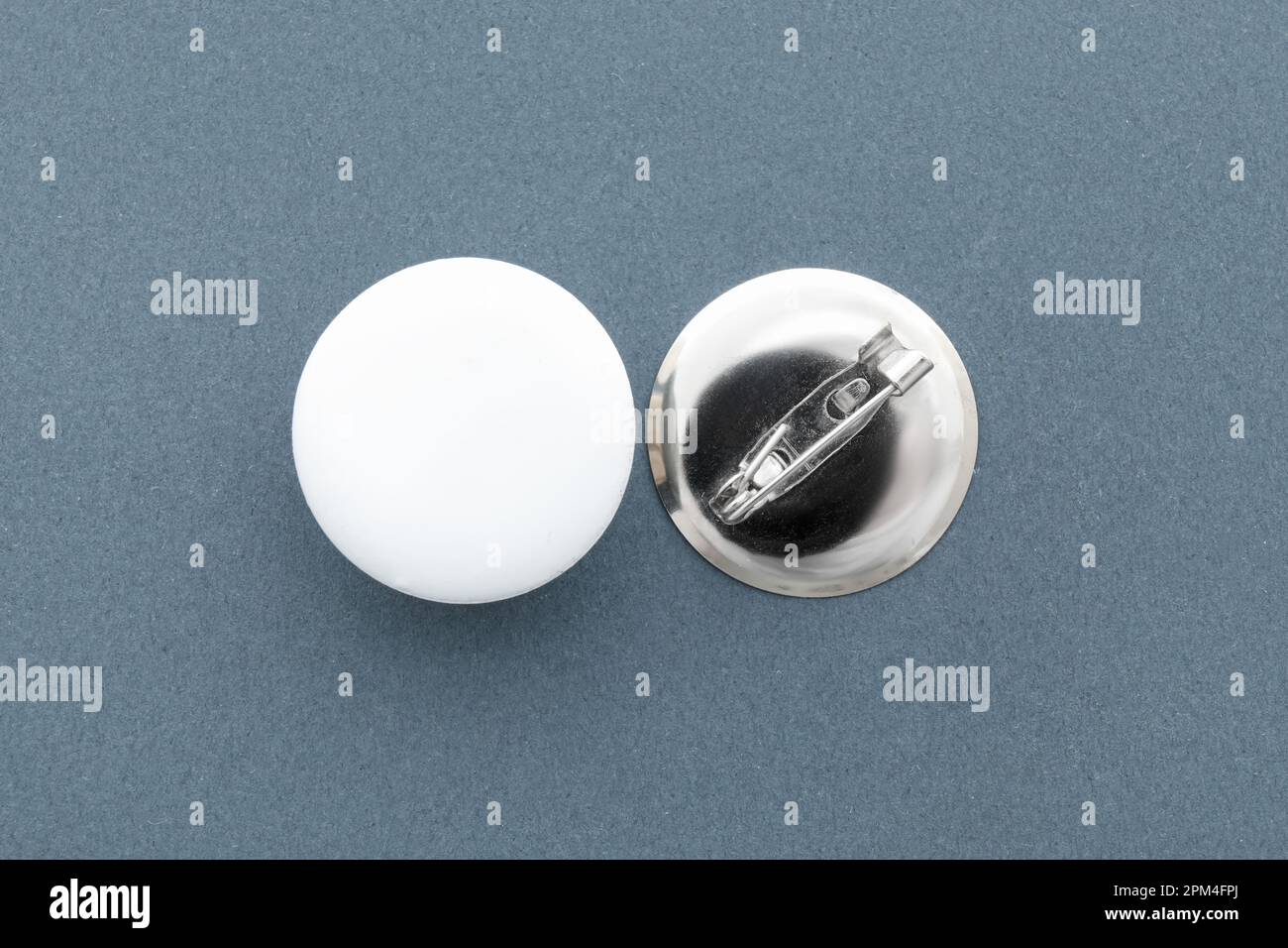 Blank white badges on grey background Stock Photo - Alamy