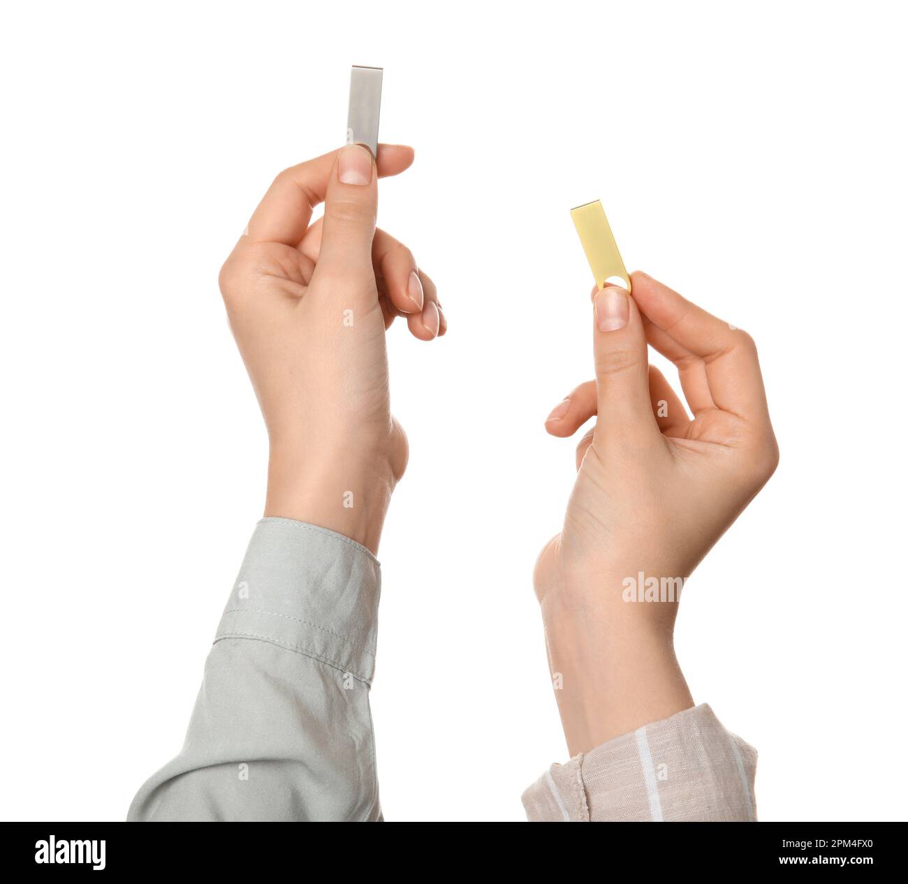 Female hands holding USB flash drives isolated on white background ...