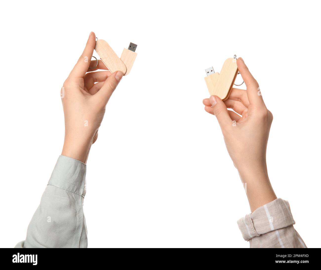 Female hands holding wooden USB flash drives isolated on white ...