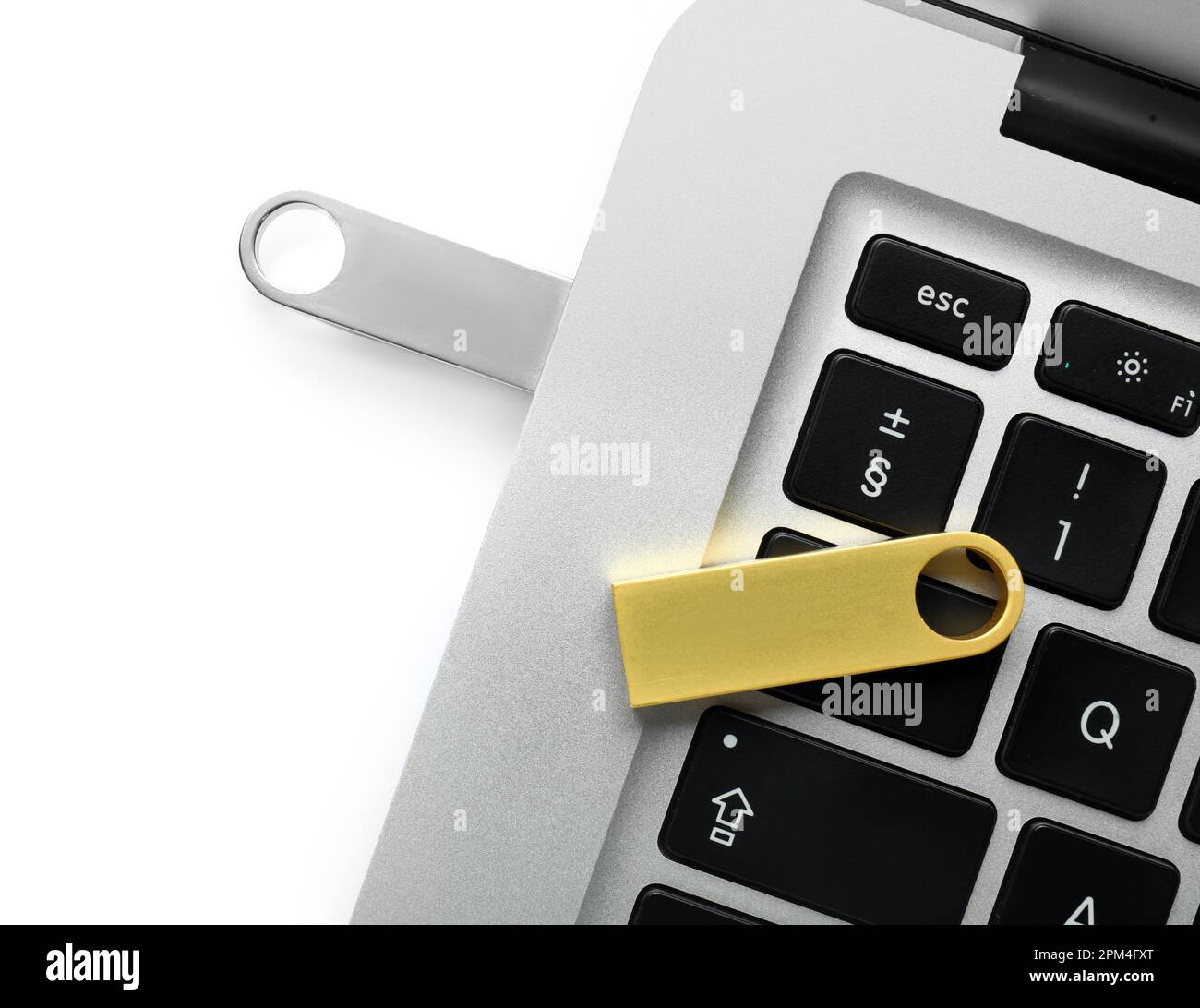 Modern laptop with metallic and golden USB flash drives isolated on ...