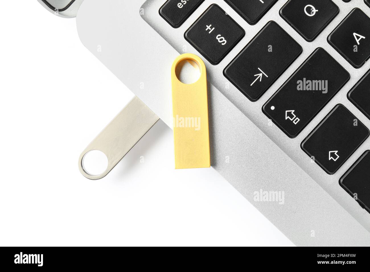 Modern laptop with metallic and golden USB flash drives isolated on ...